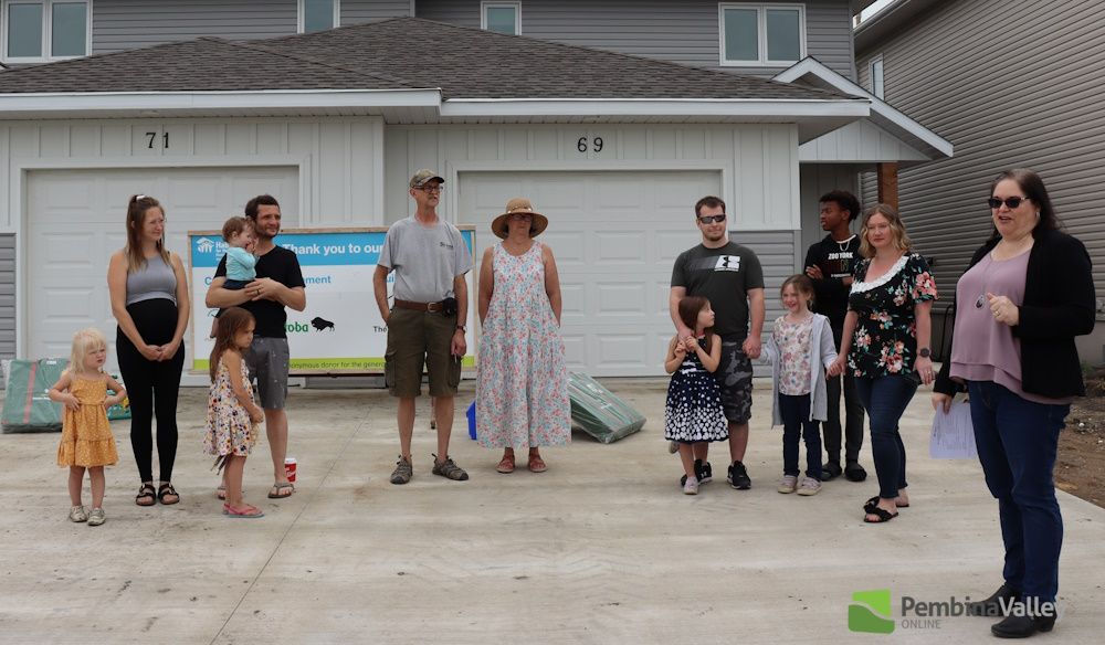 Two families given keys to a place to call their own ...